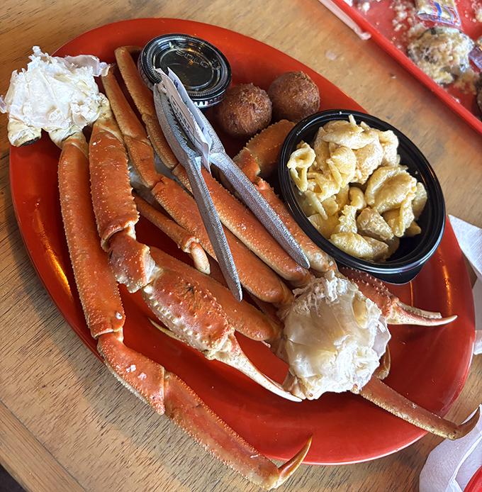 Snow crab legs arranged like a seafood sculptor's masterpiece. The accompanying hushpuppies are the unsung heroes of this oceanic feast.