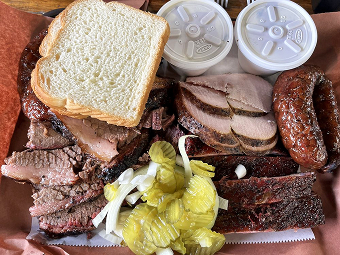 A barbecue spread that would make vegetarians weep—brisket, sausage, and ribs arranged on butcher paper like edible jewelry on Texas' favorite wrapping paper.