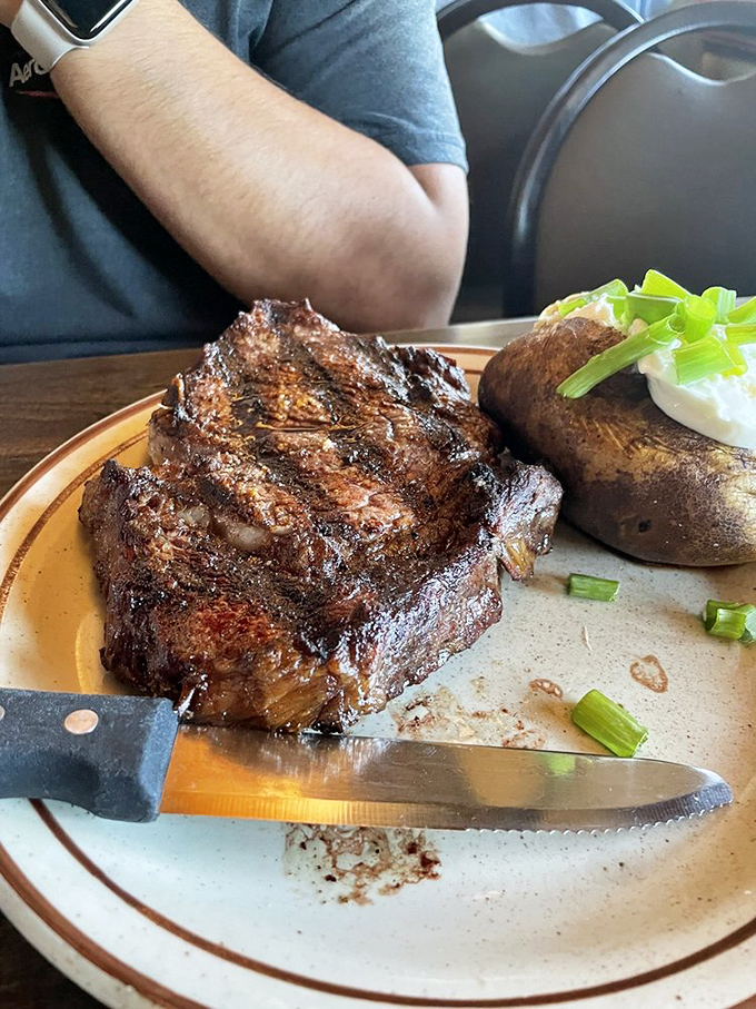 This isn't just a steak&mdash;it's a masterclass in oak-fired perfection. The knife is merely a formality; this beauty would yield to a stern look.