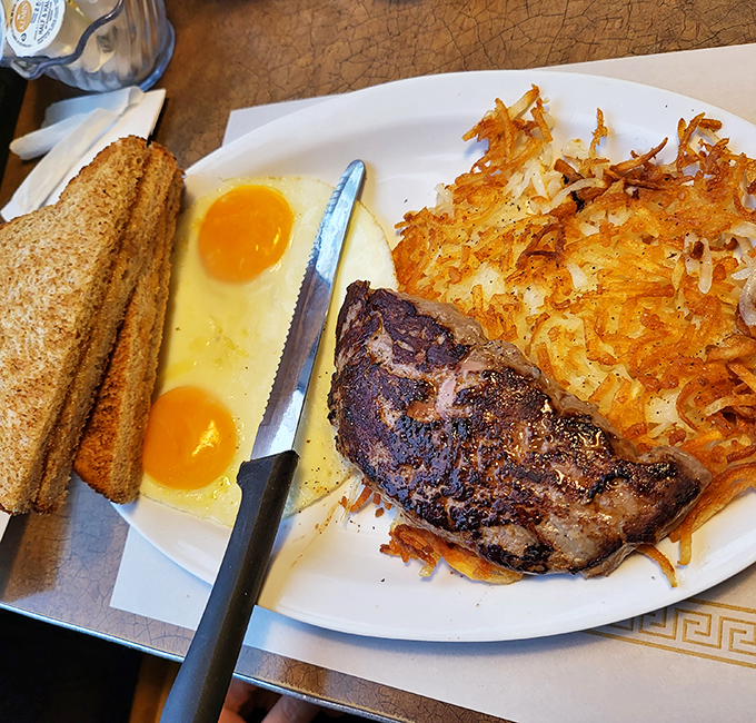 Steak and eggs: where breakfast meets dinner and nobody asks questions. Those hash browns have achieved the crispy-outside, tender-inside holy grail.