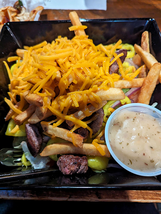 When a salad comes loaded with cheese-covered steak and fries, you know you're in a place that understands portion sizes aren't just suggestions.