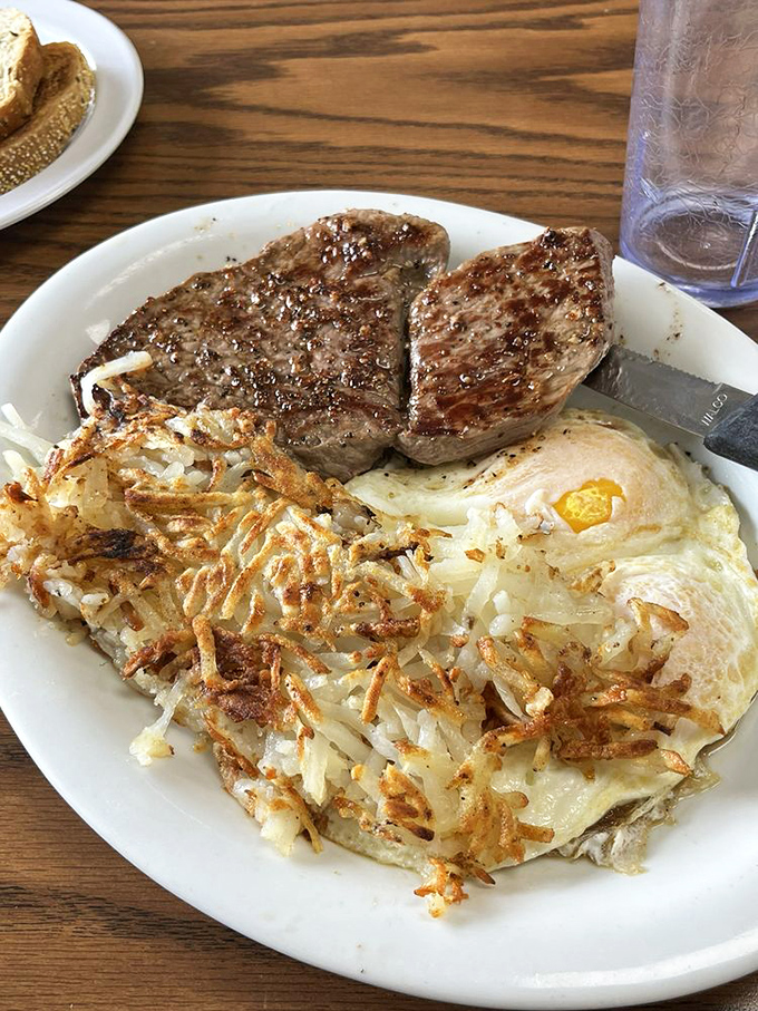 When steak and eggs get together, it's not just breakfast&mdash;it's a protein summit with crispy hash browns serving as the perfect diplomatic mediator.