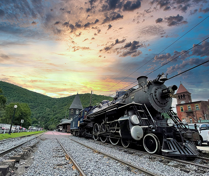 Steam Locomotive 425 commands the twilight with mechanical majesty, its headlight piercing the dusk like a time traveler from railroading's golden age.