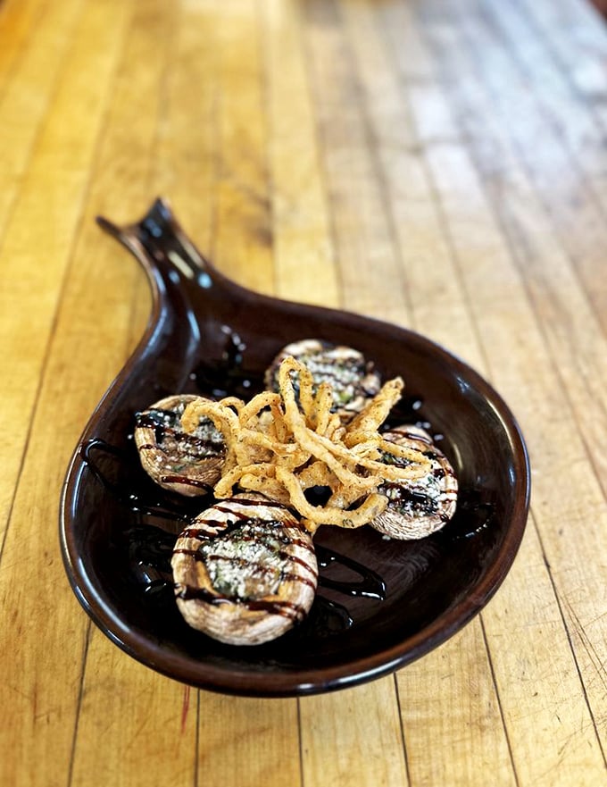 Mushrooms that have achieved their highest purpose in life. These earthy vessels carry a cargo of deliciousness topped with crispy onion treasures.