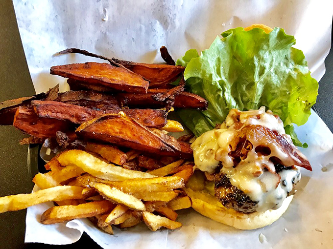 Sweet potato fries that achieve the impossible: crispy exterior, fluffy interior, and enough flavor to stand up to that magnificent burger beside them.