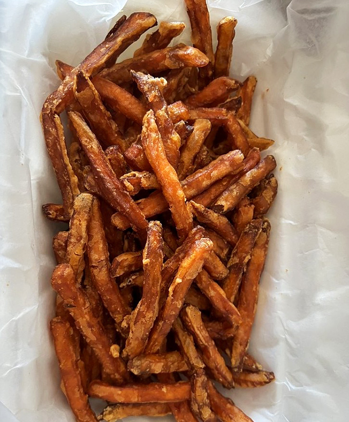 These sweet potato fries aren't just a side dish &ndash; they're crispy, golden vehicles for delivering Cajun seasoning directly to your soul.