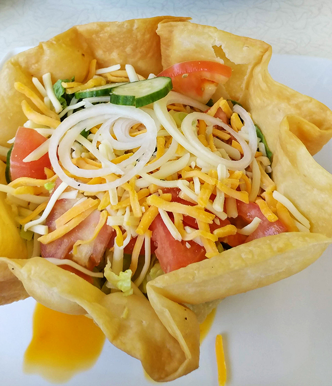 The taco salad arrives in its crispy fortress of flavor, a delicious rebellion against boring lunch options everywhere.