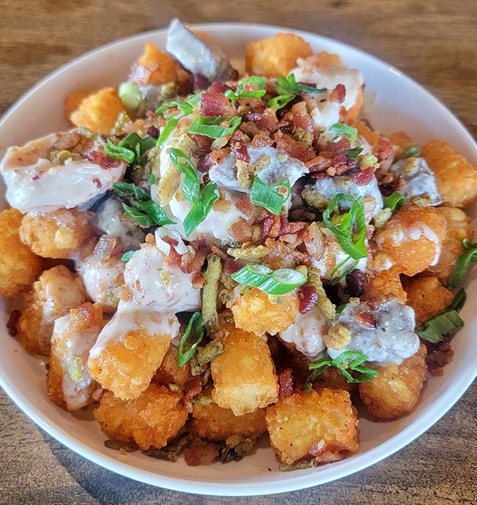 These loaded tater tots aren't just a side dish&mdash;they're the main event's scene-stealing sidekick, dressed in bacon bits and green onions.
