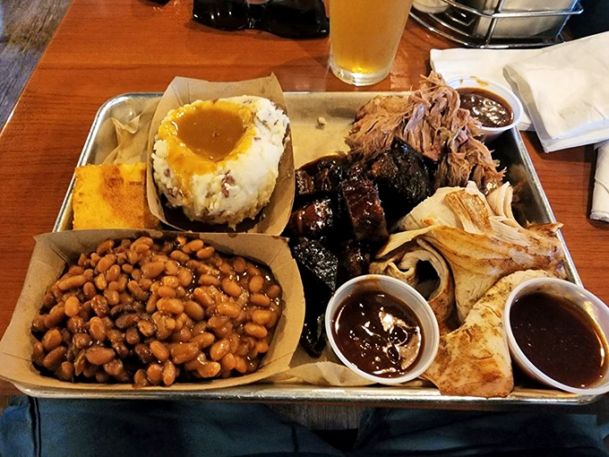 The carnivore's dream platter &ndash; pulled pork, burnt ends, and cornbread with sides that know their supporting role perfectly.