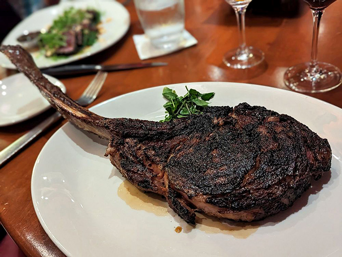 The tomahawk: part steak, part theatrical performance. When it arrives at your table, conversations stop and necks crane to witness its majesty.