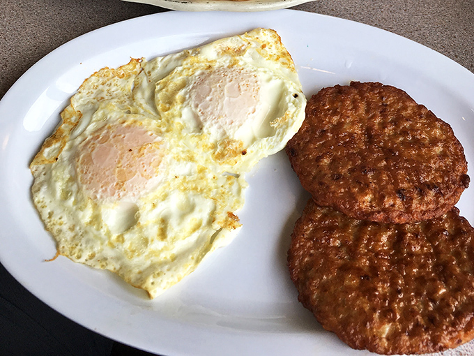 Perfectly fried eggs with crispy edges alongside turkey sausage patties with a beautiful sear. Breakfast fundamentals executed with the precision of a culinary symphony.