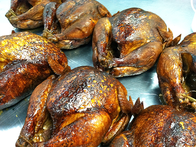 Golden-brown smoked turkeys lined up like delicious soldiers, ready to report for dinner duty at your table.