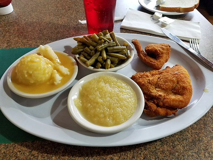 The holy trinity of comfort: perfectly fried chicken, applesauce, and green beans. Grandma would approve, then steal a bite.