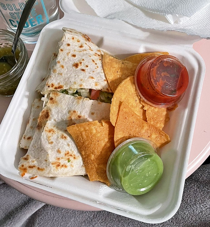 Triangles of joy served with chips and two salsas. The to-go container says "I'm leaving" but your taste buds say "We're staying forever."