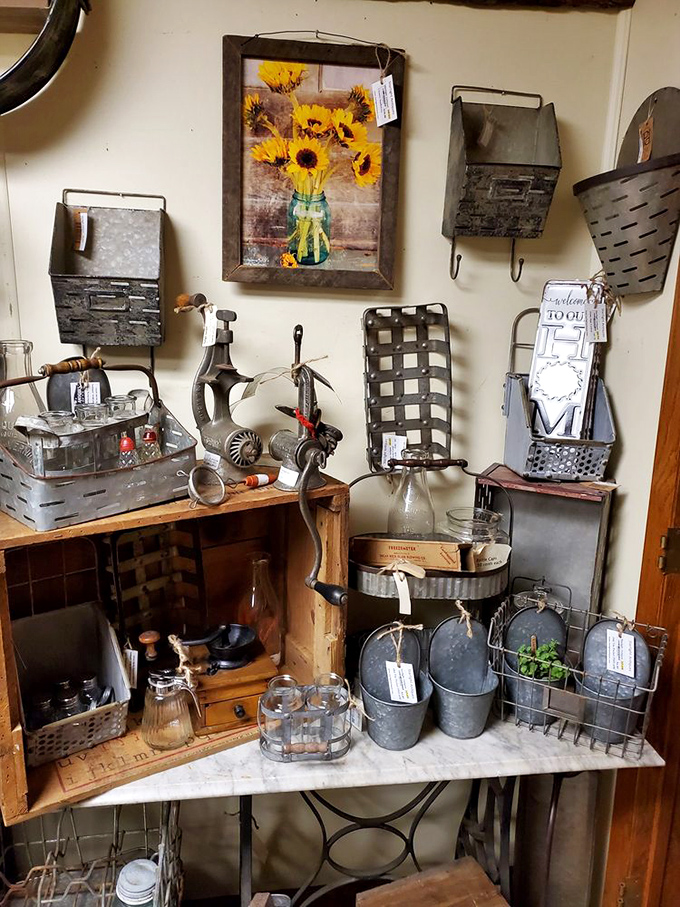 A perfectly curated vignette of farmhouse treasures. That sunflower print brings warmth to the collection of galvanized metal and vintage tools.