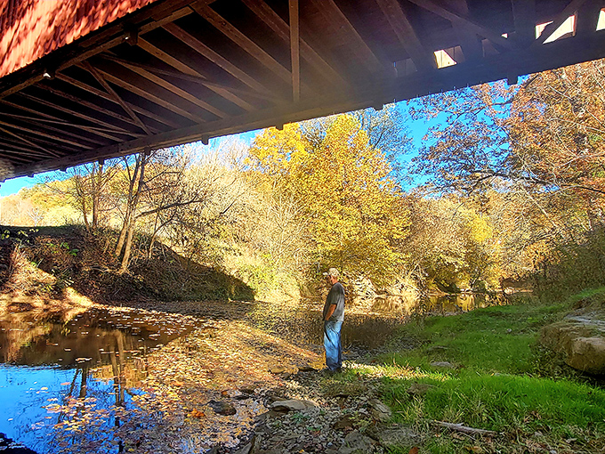 Sunshine bathes the creek beneath the bridge, where generations have skipped stones and cooled their feet on sweltering summer days.