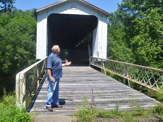 Every historic bridge deserves an enthusiastic tour guide! The white-painted entrance contrasts beautifully with the weathered wooden interior.