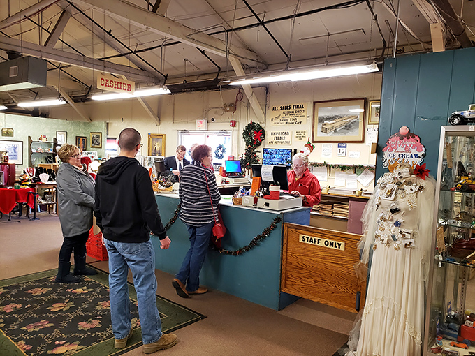 The checkout counter buzzes with the energy of successful treasure hunters, where today's finds become tomorrow's heirlooms amid festive holiday decorations.