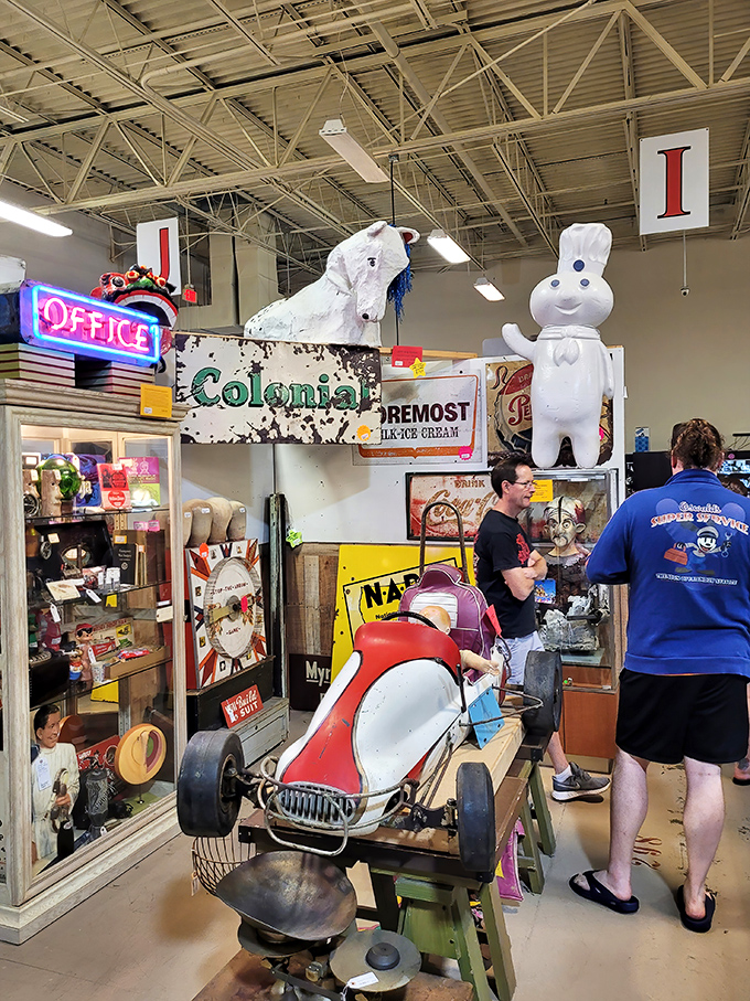 Vintage advertising signs tower above shoppers like the ghosts of marketing past. That Pillsbury Doughboy never ages, unlike the rest of us.