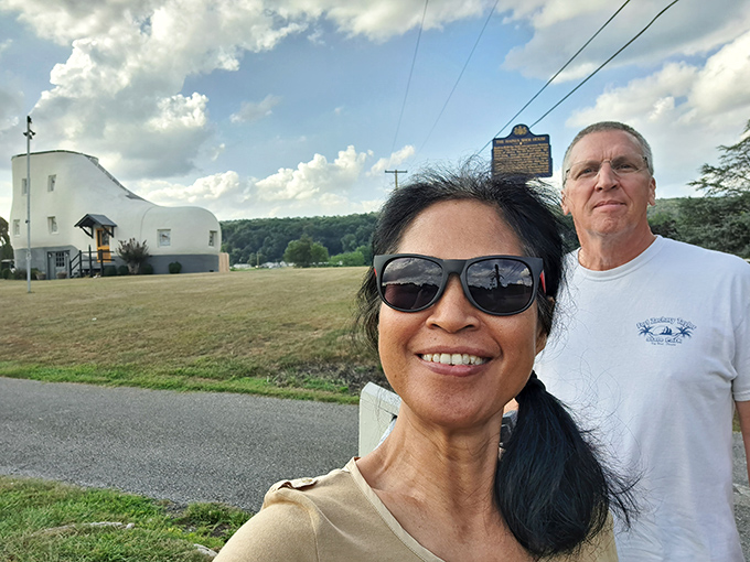 Visitors capture the obligatory "we were here" shot. The real challenge is explaining to friends back home that you weren't kidding about sleeping in a shoe.