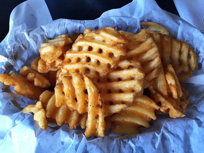 Waffle fries that achieve the impossible trifecta: crispy exterior, fluffy interior, and enough structural integrity to support whatever dipping adventure you choose.