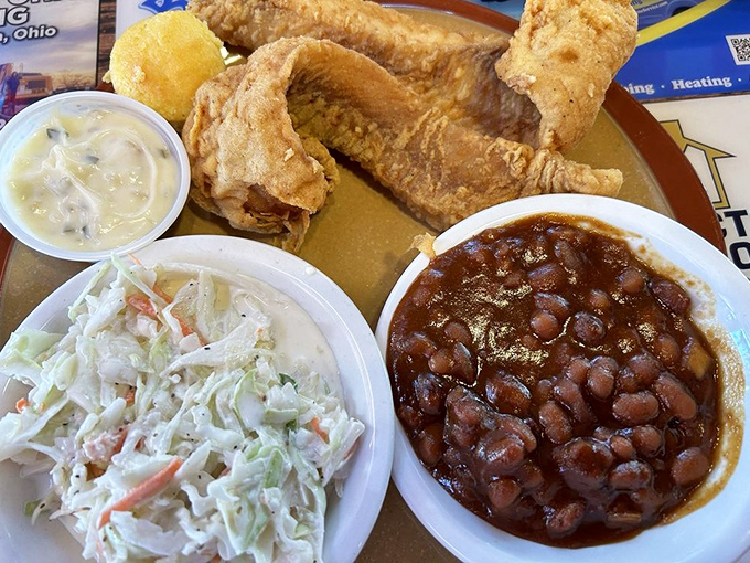 Golden fried walleye with creamy coleslaw and baked beans&mdash;the holy trinity of Midwestern comfort that makes you feel instantly at home.