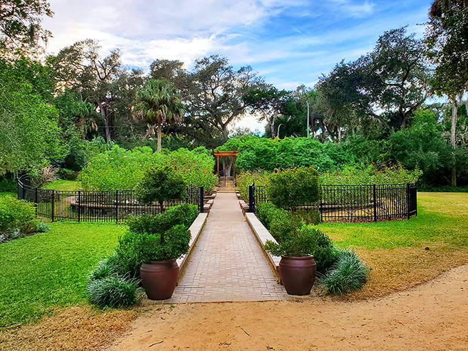 A garden path that promises serenity ahead. Washington Oaks Gardens State Park combines formal landscaping with wild Florida beauty in perfect, Instagram-worthy harmony.