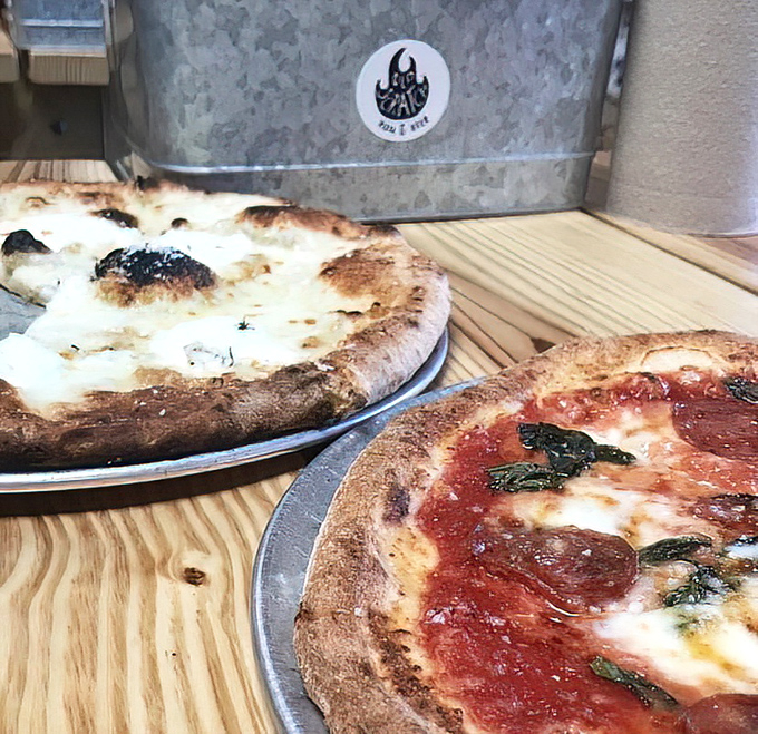 A study in contrasts: pillowy crust with perfect char marks alongside a white pie that would make an Italian grandmother weep with joy.