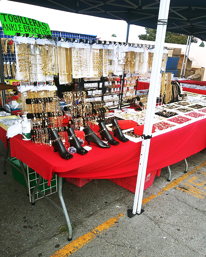 Gold chains, ankle bracelets, and jewelry displays transform this humble tent into a treasure chest of affordable bling.