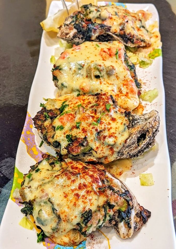 Oysters living their best afterlife. These baked beauties, smothered in cheese and seasonings, prove that sometimes playing with fire leads to delicious results.