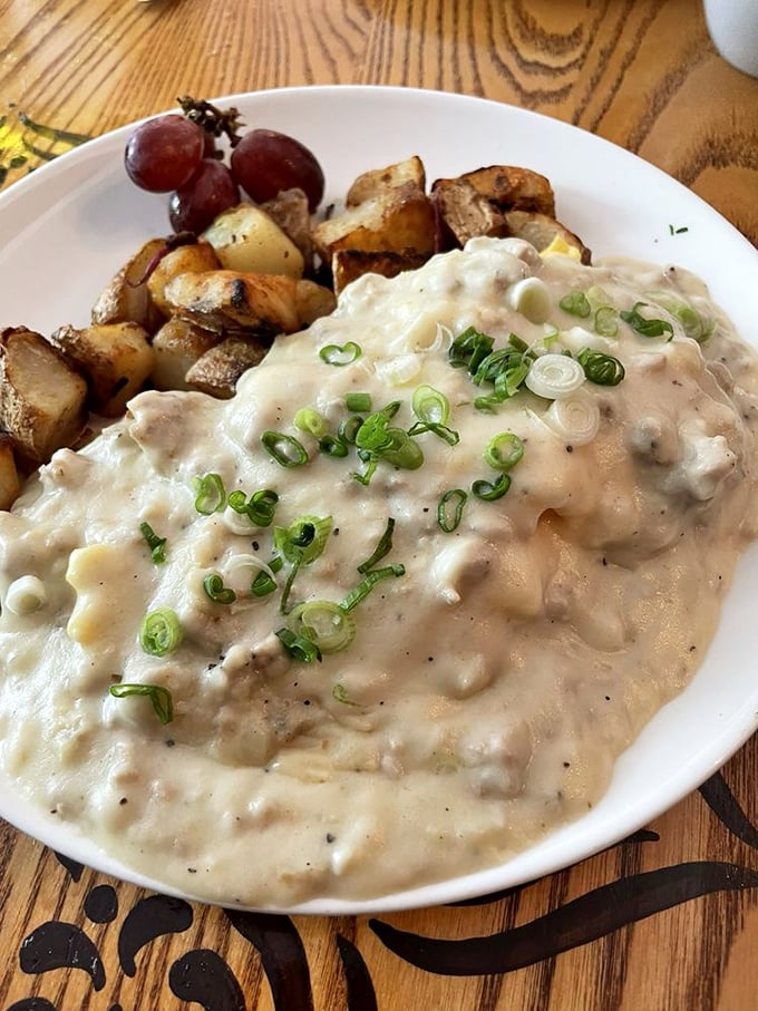 Behold the holy grail of comfort food: fluffy biscuits drowning in creamy sausage gravy perfection.