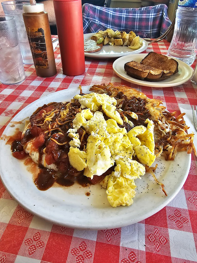 This isn't just breakfast&mdash;it's edible therapy. Eggs, hash browns, and what appears to be chili, creating the holy trinity of morning satisfaction.