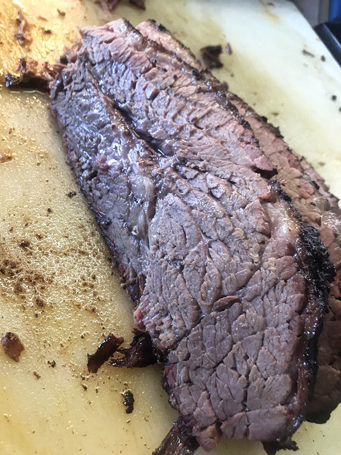 Brisket so tender it practically surrenders to your fork. That smoke ring isn't just for show &ndash; it's a flavor halo around meat heaven.
