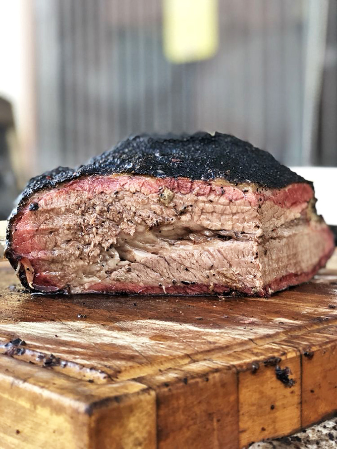 Behold the holy grail of barbecue: brisket with that textbook smoke ring and pepper-crusted bark that makes Texans nod in solemn approval.