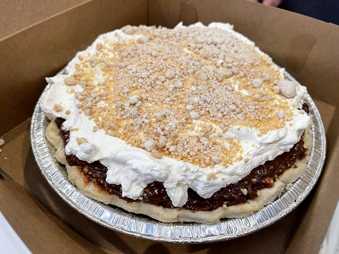 This isn't just pie&mdash;it's edible therapy. The crumble-topped creation sits in its aluminum throne, waiting to solve all your problems one bite at a time.
