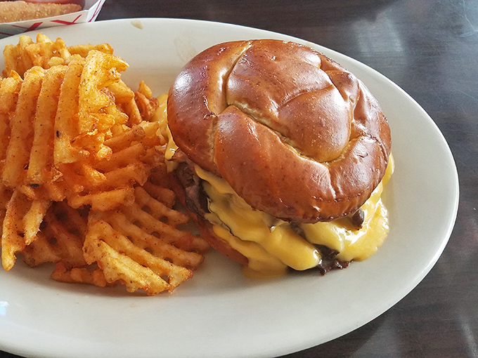 A proper tavern burger should require both hands, a stack of napkins, and possibly a game plan before the first bite.