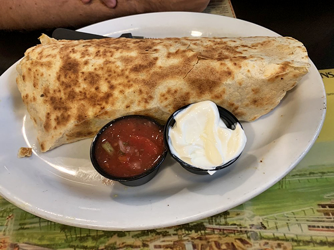The famous Burrito Buster in all its glory &ndash; a tortilla-wrapped miracle served with fresh salsa and sour cream that makes morning meetings worth attending.