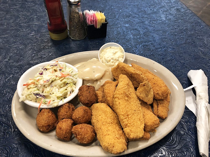 Golden-fried catfish with hushpuppies and slaw &ndash; proof that sometimes the best things in life come breaded, fried, and served with a side of nostalgia.
