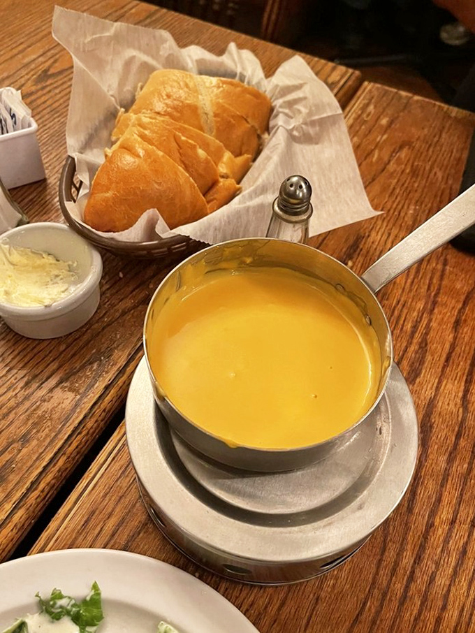 The cheese fondue arrives like liquid gold, accompanied by fresh sourdough. A throwback appetizer that proves everything old becomes deliciously new again.