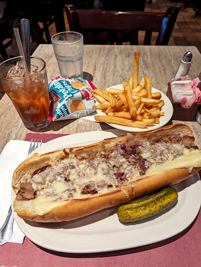 The Philadelphia cheesesteak in its natural habitat. Tender meat, melty cheese, and a pickle sidekick that knows its supporting role perfectly.