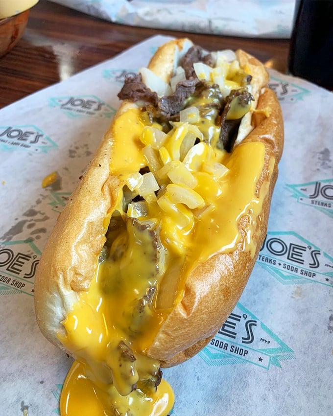 The Cheez Whiz cascading down this cheesesteak isn't just melting&mdash;it's performing a golden waterfall dance that would make Niagara Falls jealous.