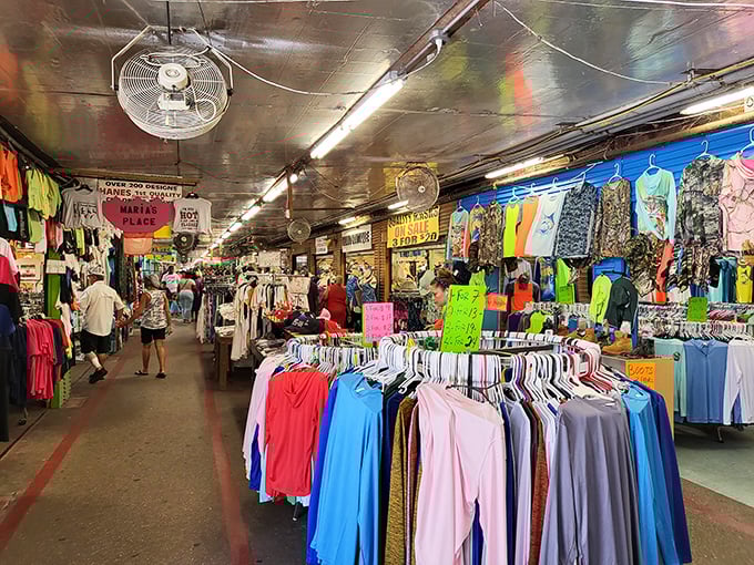 The clothing aisles stretch endlessly, a kaleidoscope of colors where fashion trends from every decade coexist in perfect harmony.