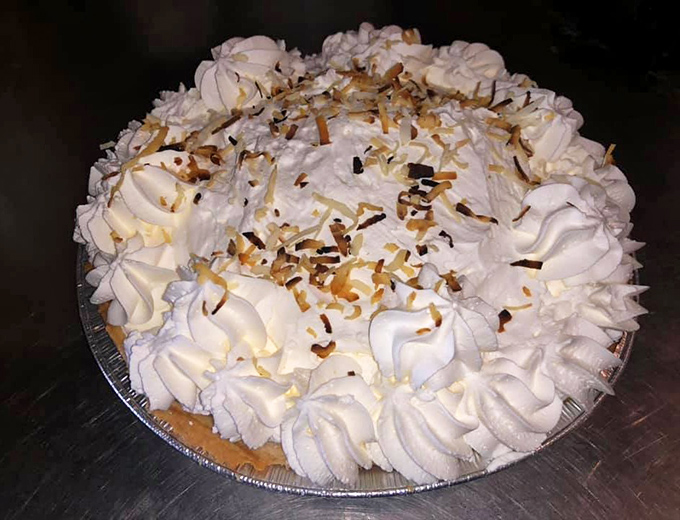 Coconut cream pie with peaks of whipped topping and toasted coconut flakes&mdash;the kind of dessert that makes you close your eyes with each bite.