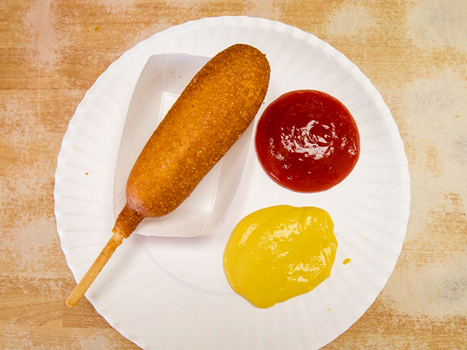The humble corn dog &ndash; childhood nostalgia on a stick, golden-fried to perfection and waiting for that first satisfying crunch.