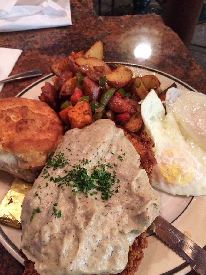 Country fried steak smothered in gravy alongside eggs and seasoned potatoes&mdash;a breakfast that says "go back to bed after this" in the most delicious way possible.