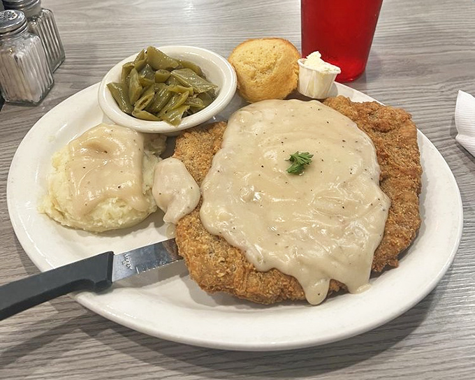 Country fried steak swimming in gravy so good you'll be tempted to drink it with a straw. The green beans are just there for moral support.