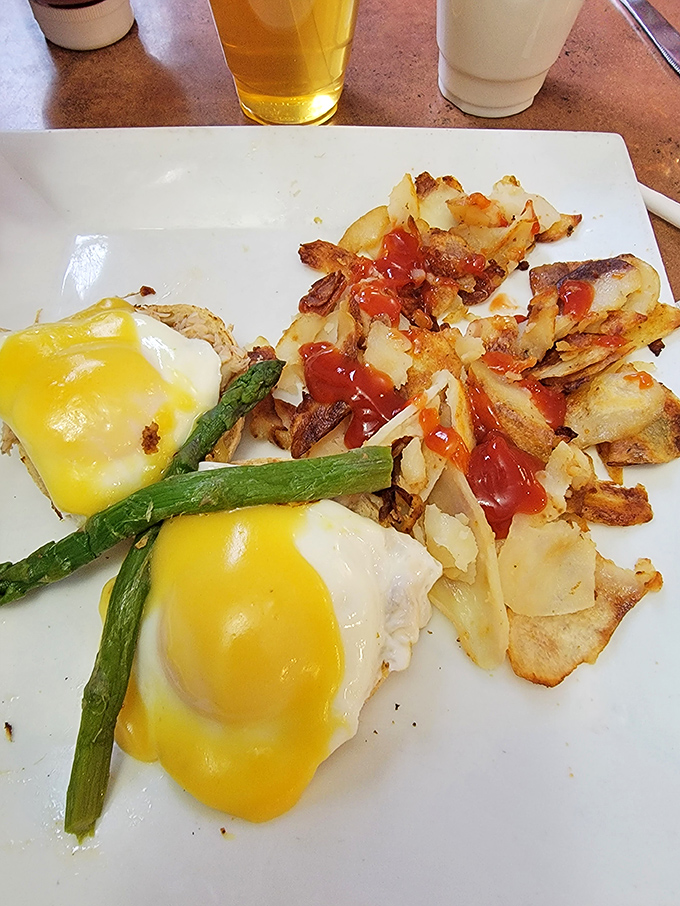 Crab Benedict with asparagus spears standing at attention, as if saluting the hollandaise sauce cascading down like sunshine.