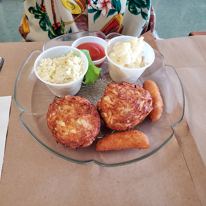 Golden crab cakes paired with creamy sides &ndash; this is comfort food that knows how to dress up properly.