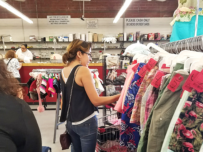 The universal thrift store dance: examining potential treasures while mentally rearranging your closet to make room for "just one more" find.