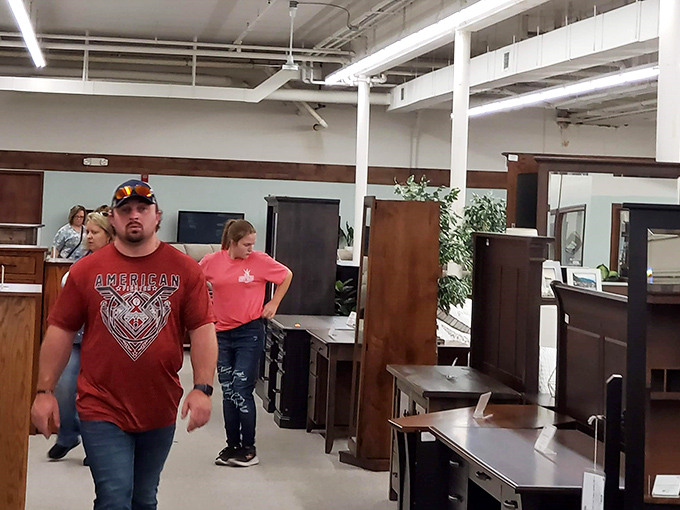 Treasure hunters in their natural habitat, navigating aisles of history. The serious expressions say it all &ndash; antiquing is serious business!
